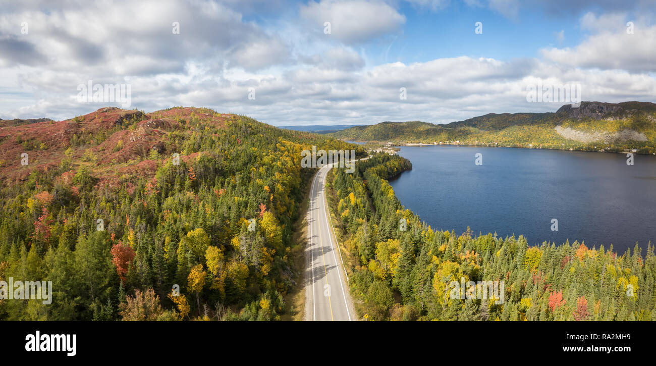 Aerial panoramic view of a scenic road during a vibrant sunny day ...