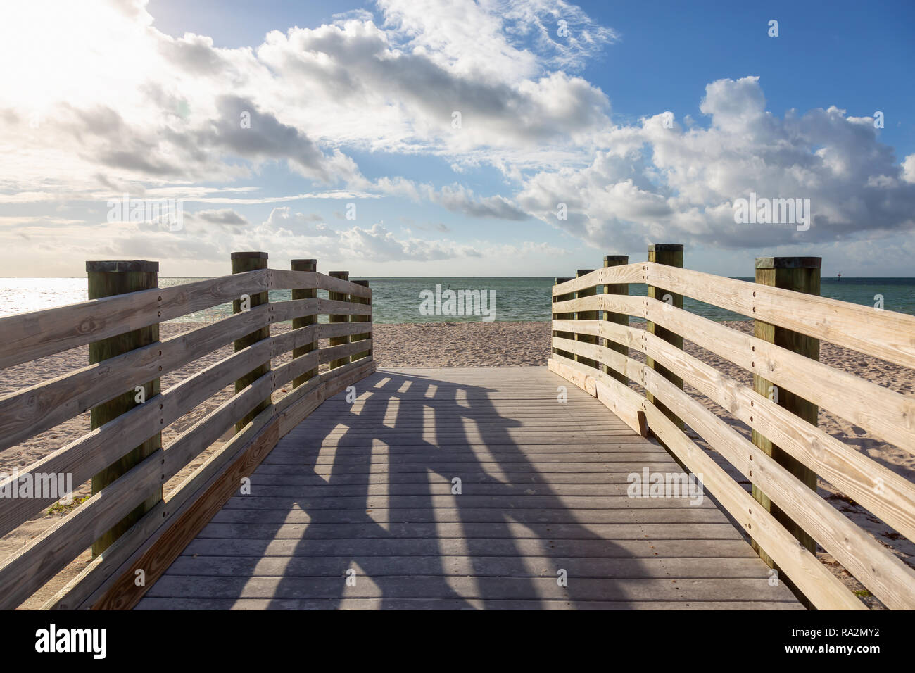 Wooden platform on a sandy beach during a vibrant sunny day. Taken in ...