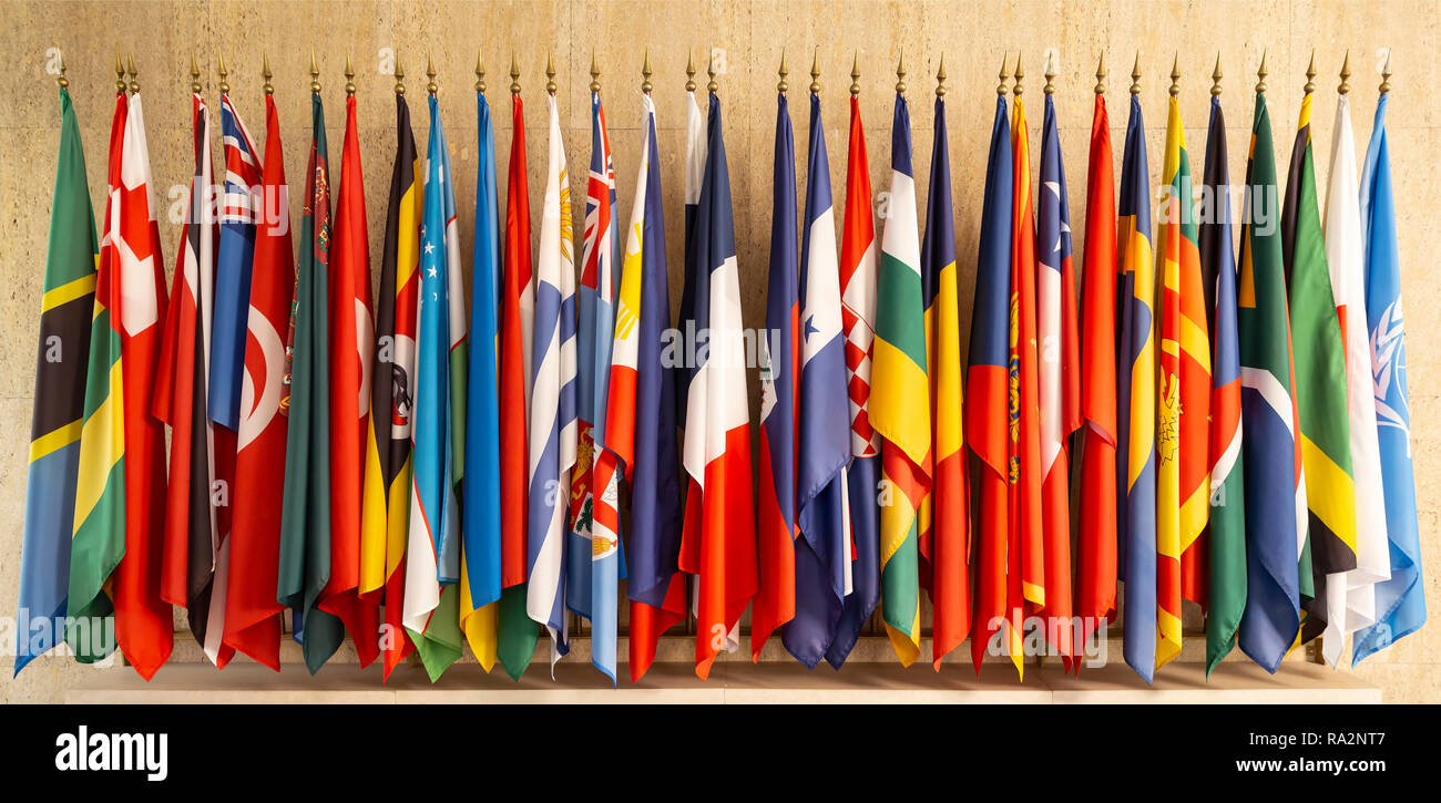 Some world national flags on poles on a wall Stock Photo - Alamy