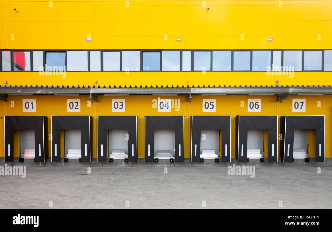 Seven truck loading docks at a distribution warehouse. Distribution hub ...