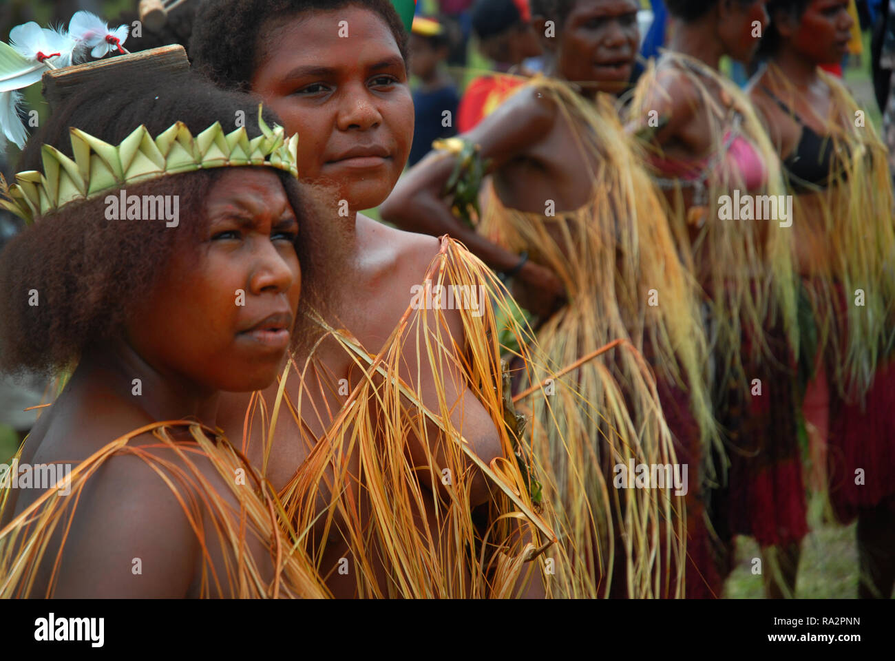 Colourfully dressed and face painted girls waiting to dance as part of ...