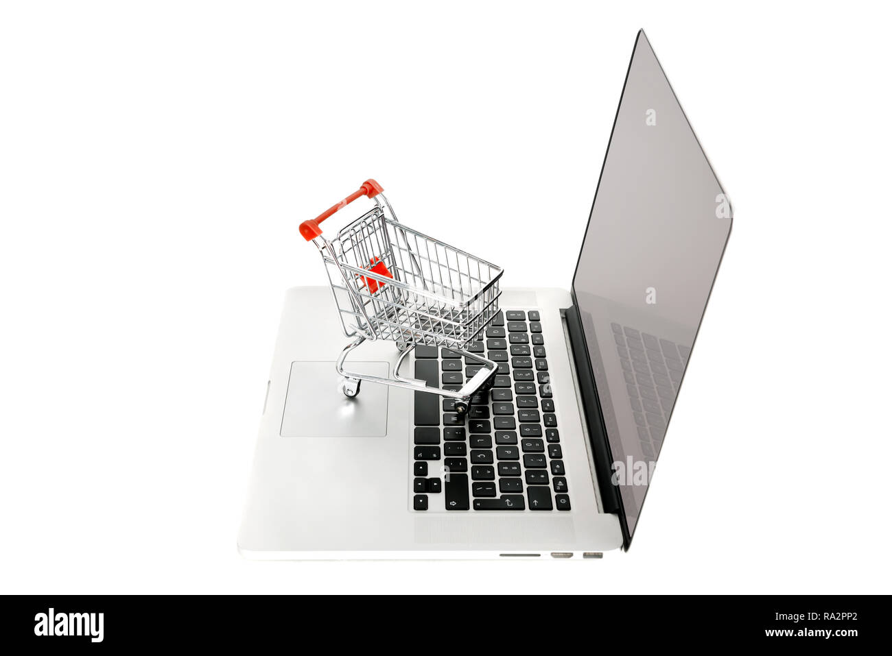 Laptop with small shopping cart isolated in white Stock Photo - Alamy