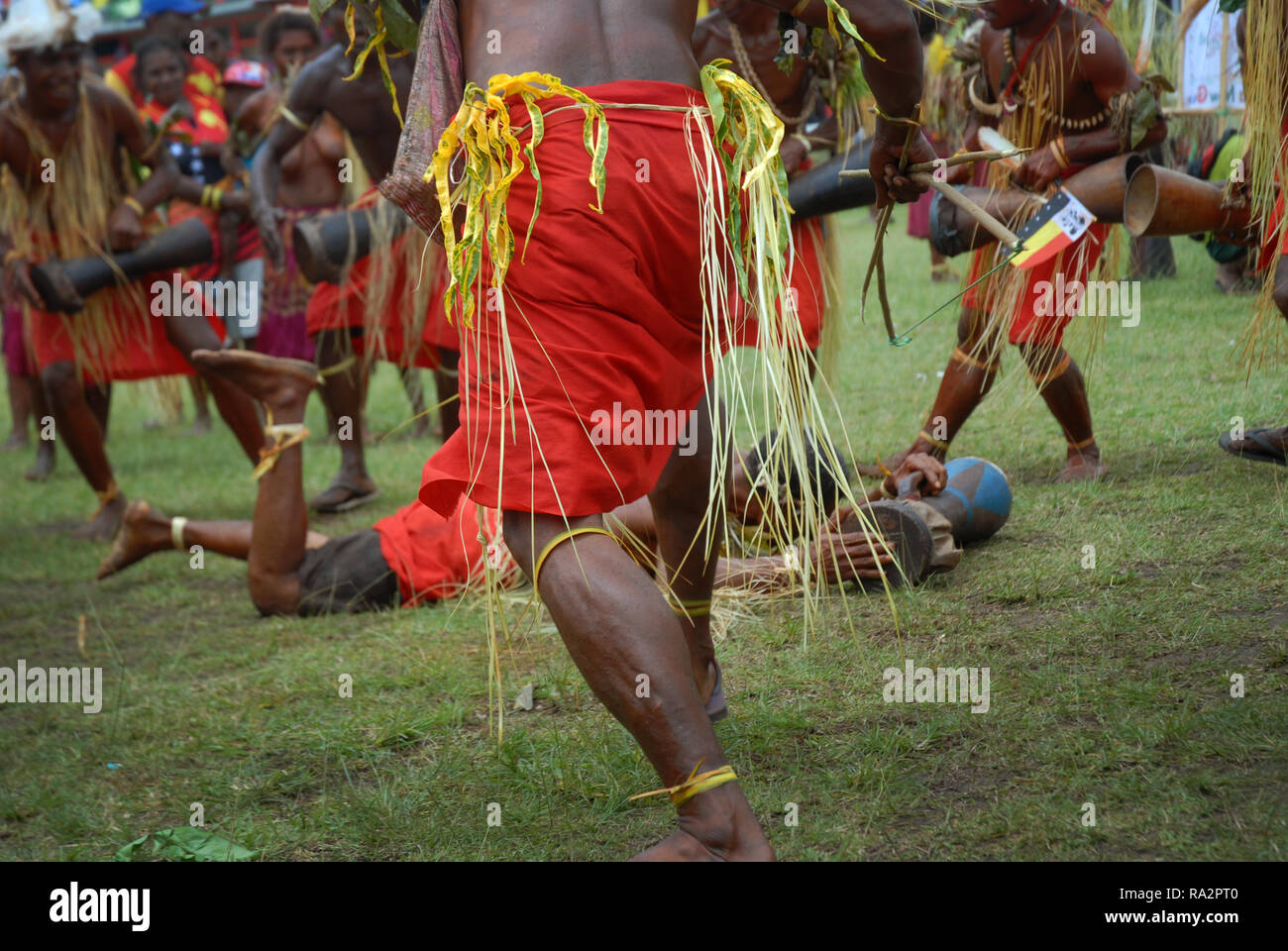 Colourfully dressed and face painted men performing as part of the ...