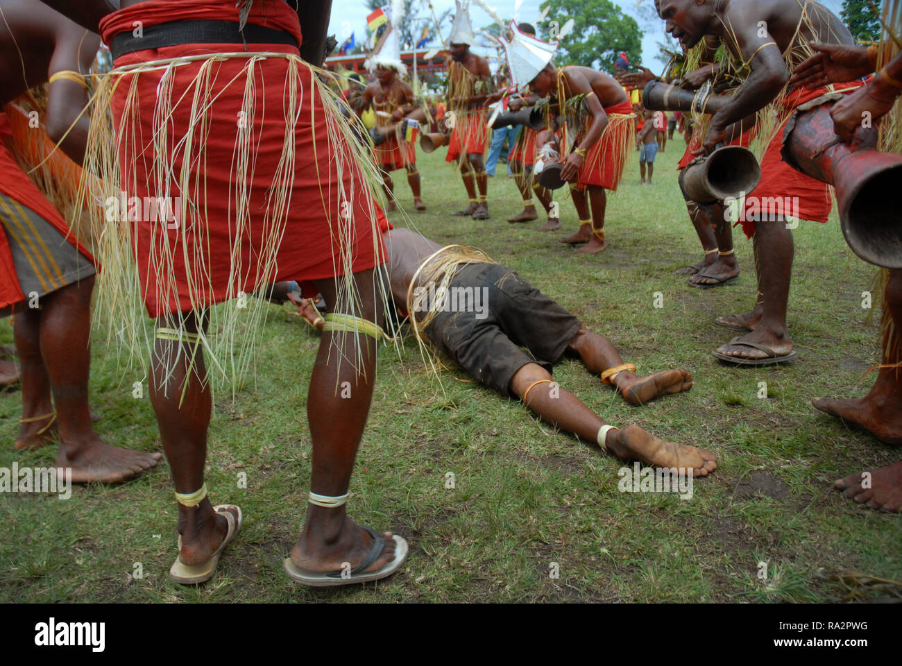 Colourfully dressed and face painted men performing as part of the ...