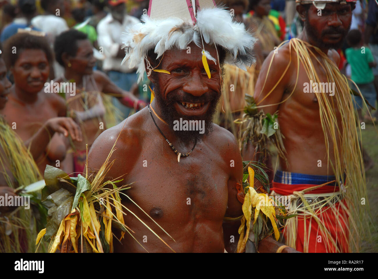 Colourfully dressed and face painted man smiling as part of the annual ...