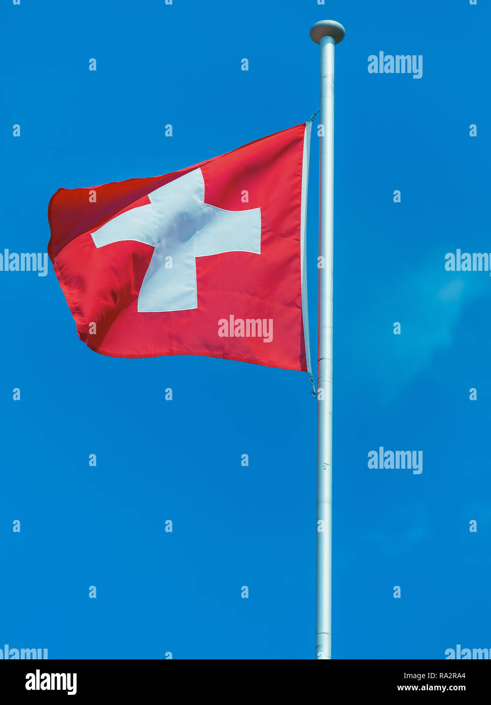 Swiss waving flag against blue hi-res stock photography and images - Alamy