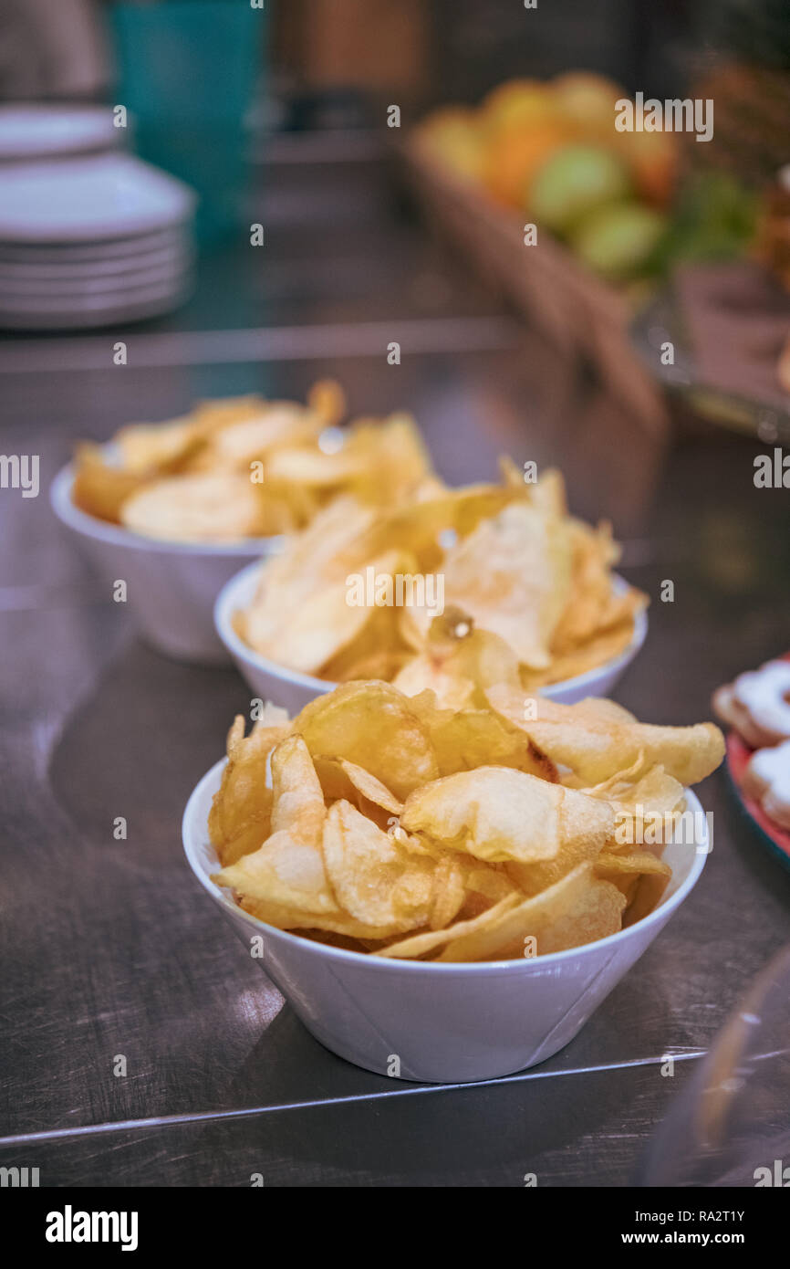 Close up of bowl full of fried potato chips ready to serve at pub ...