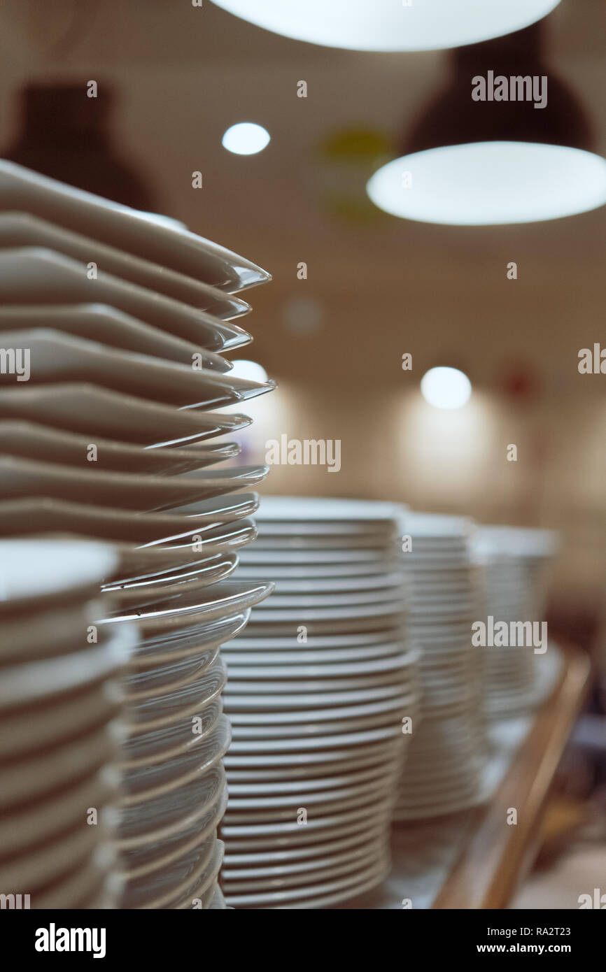 Close up of pile of empty plates in kitchen defocused background Stock ...