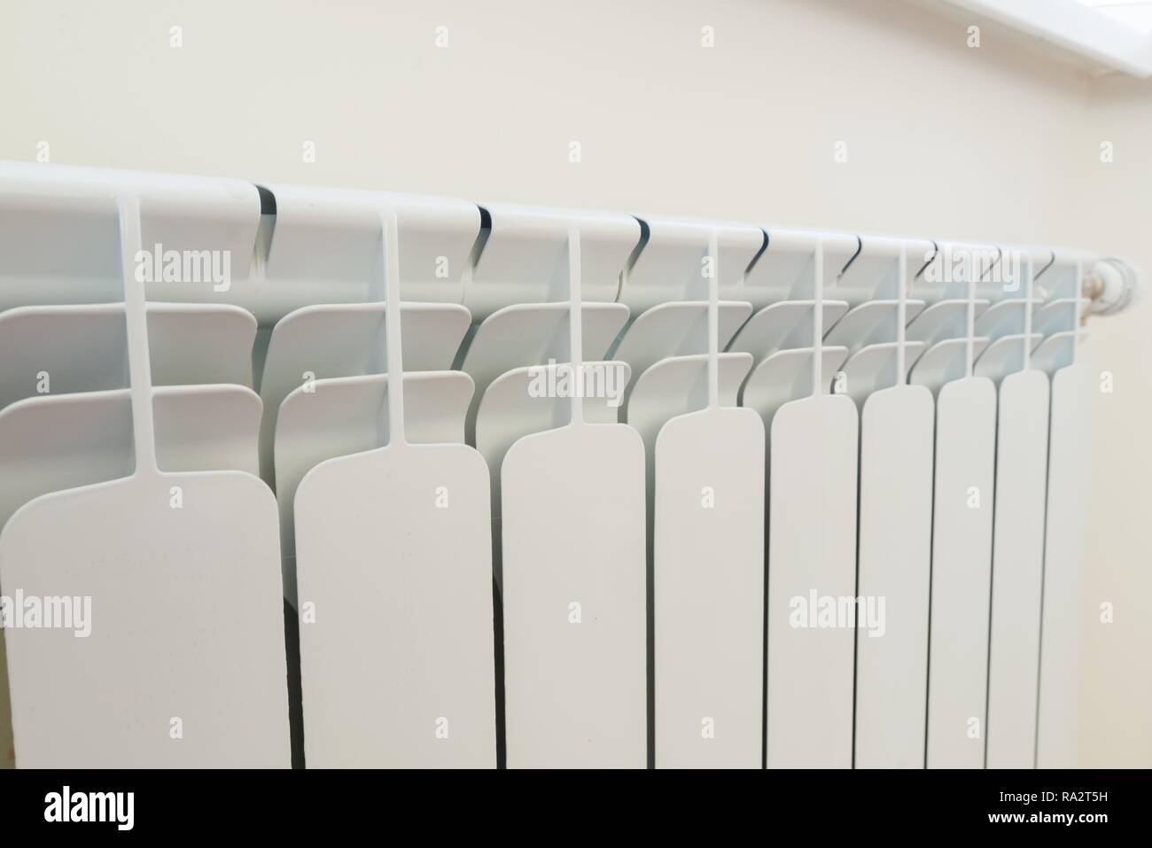White aluminum radiator heating panel in the interior Stock Photo - Alamy