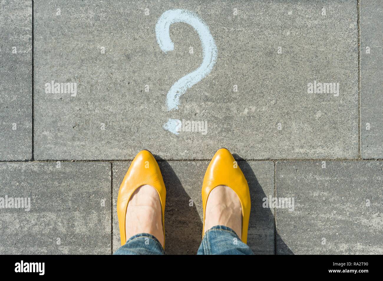 Woman feet with question mark in front of her legs painted on the ...