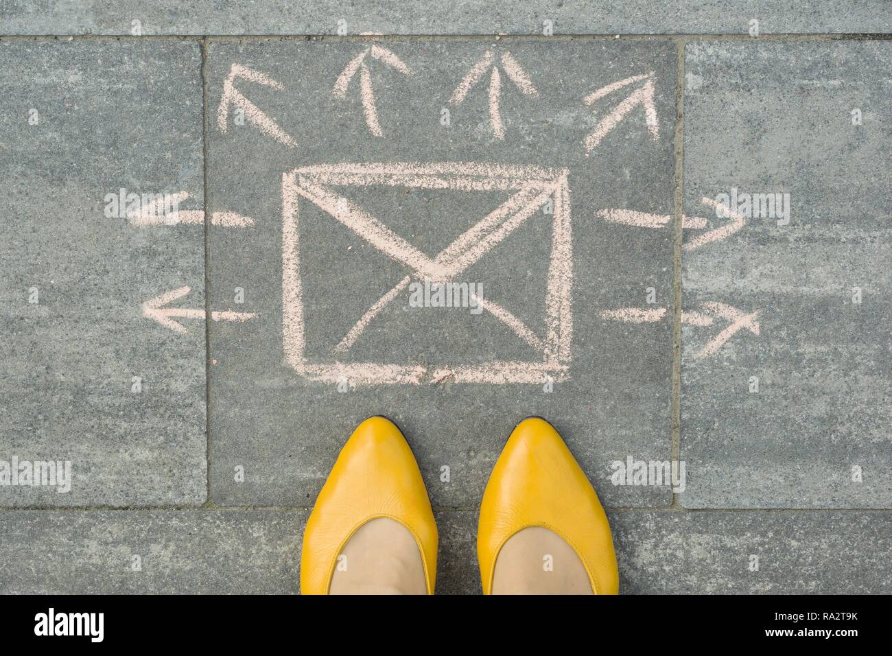 Female feet with abstract envelope message letter with arrows in ...