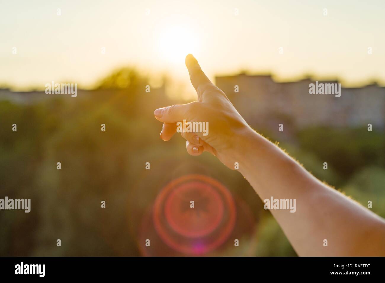 Gesture with the index finger towards the sunset. Background sky ...