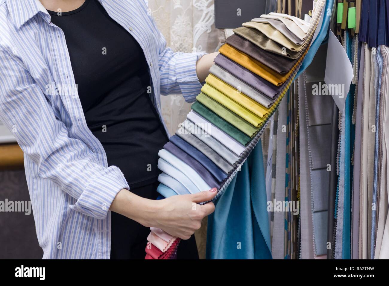 Fabrics Store, female looking and touching samples, female designer ...