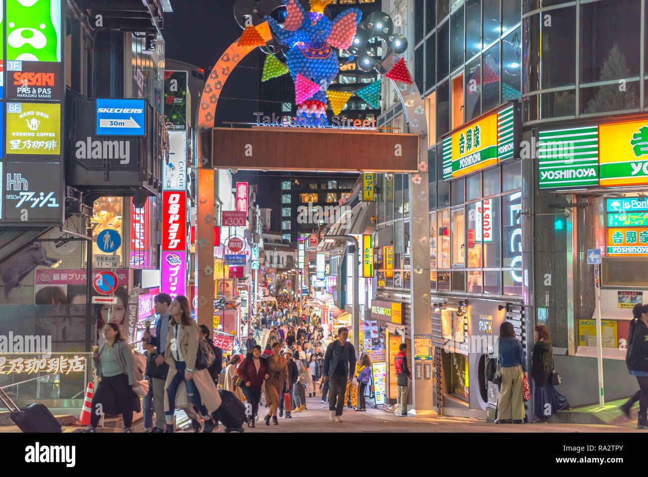 People,mostly youngsters, walk through Takeshita Street, a famous ...