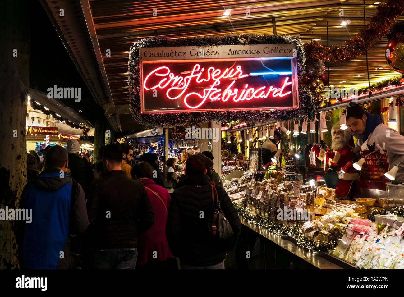 Traditional food booth at the Christmas market of Strasbourg at night ...
