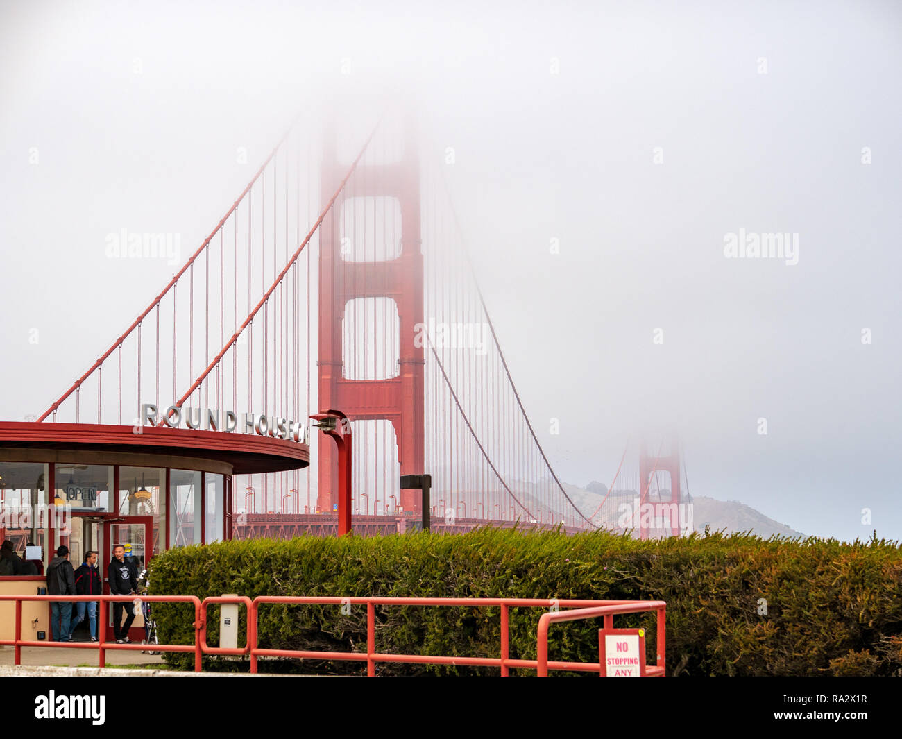 Golden Gate Bridge and Roundhouse Cafe peeking through fog Stock Photo ...