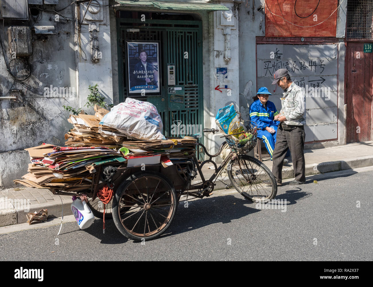 Local worker collects cardboard for recycling with bicycle Stock Photo ...