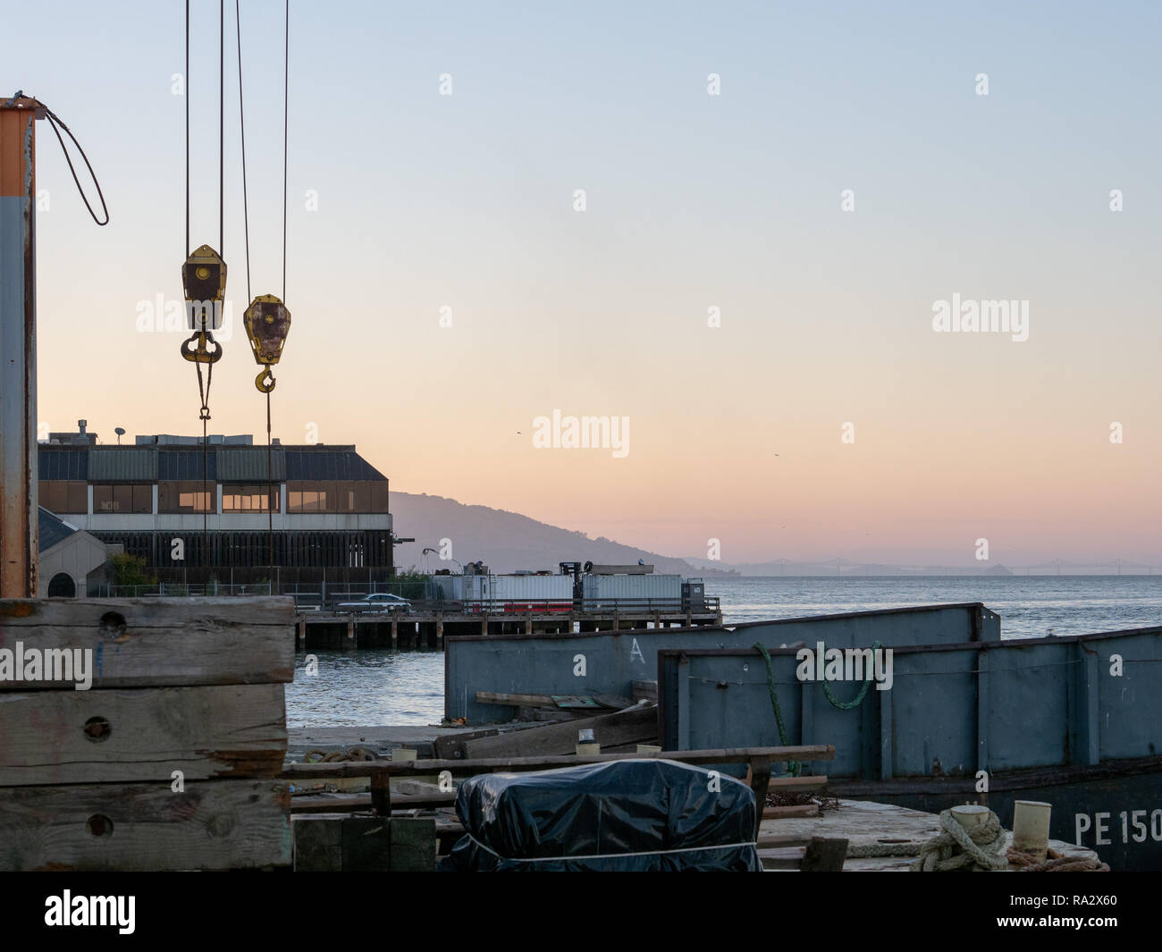 Various parts of machinery, pulleys, shipping equipment in a dock area ...