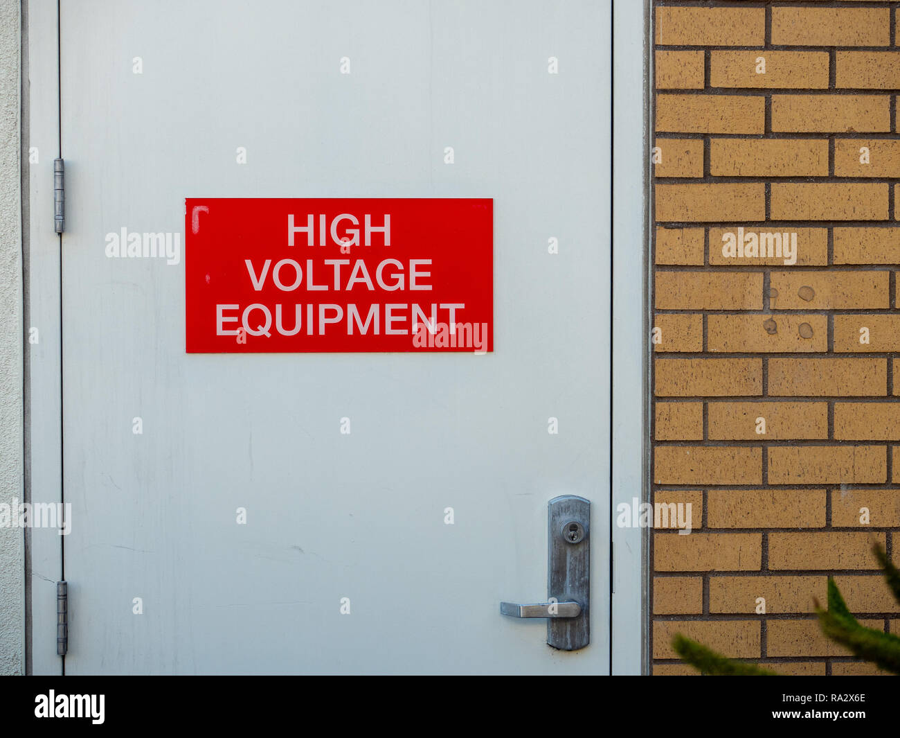 High voltage equipment warning sign posted on door outside Stock Photo ...