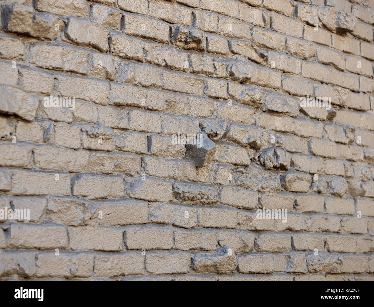 Dark gray covered brick wall with light reflecting off out doors Stock ...