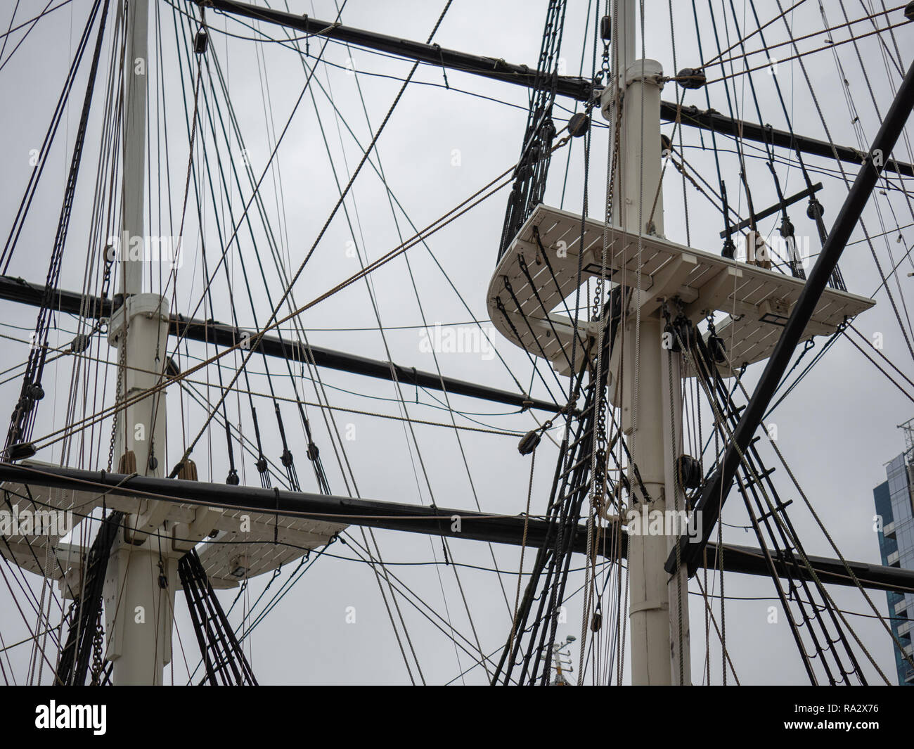 Spars and shrouds of a historical classic frigate ship holding rigging ...