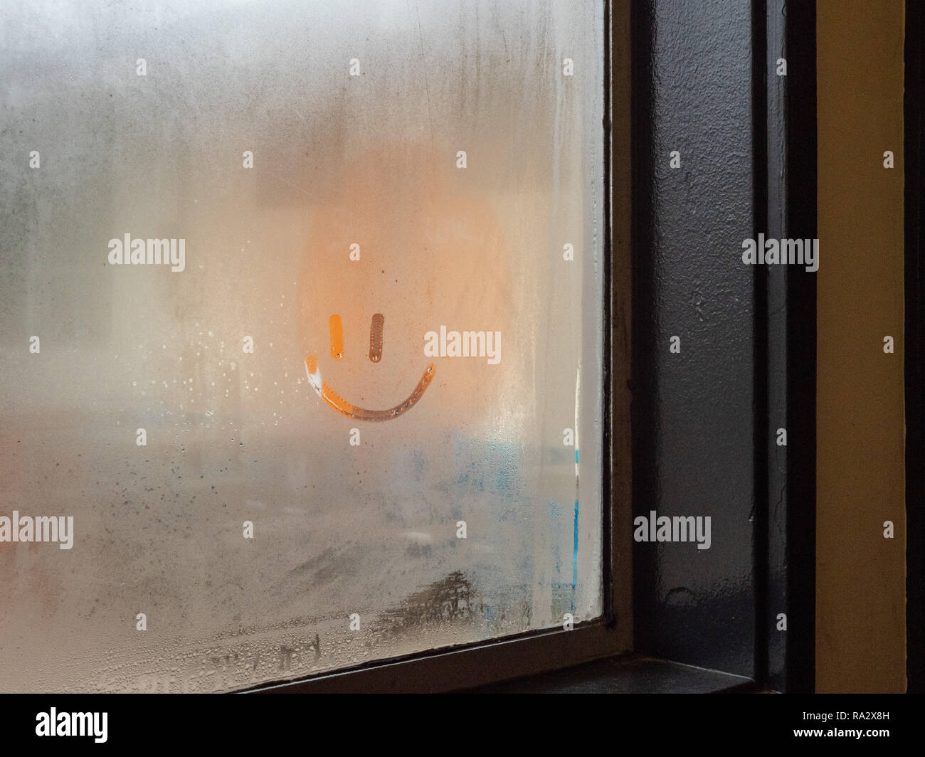 Smiley face drawn in condensation and foggy window in restaurant Stock ...
