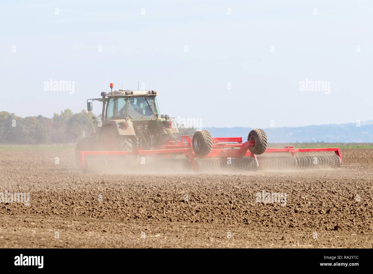 Tractor preparing field, Agriculture tractor Stock Photo - Alamy