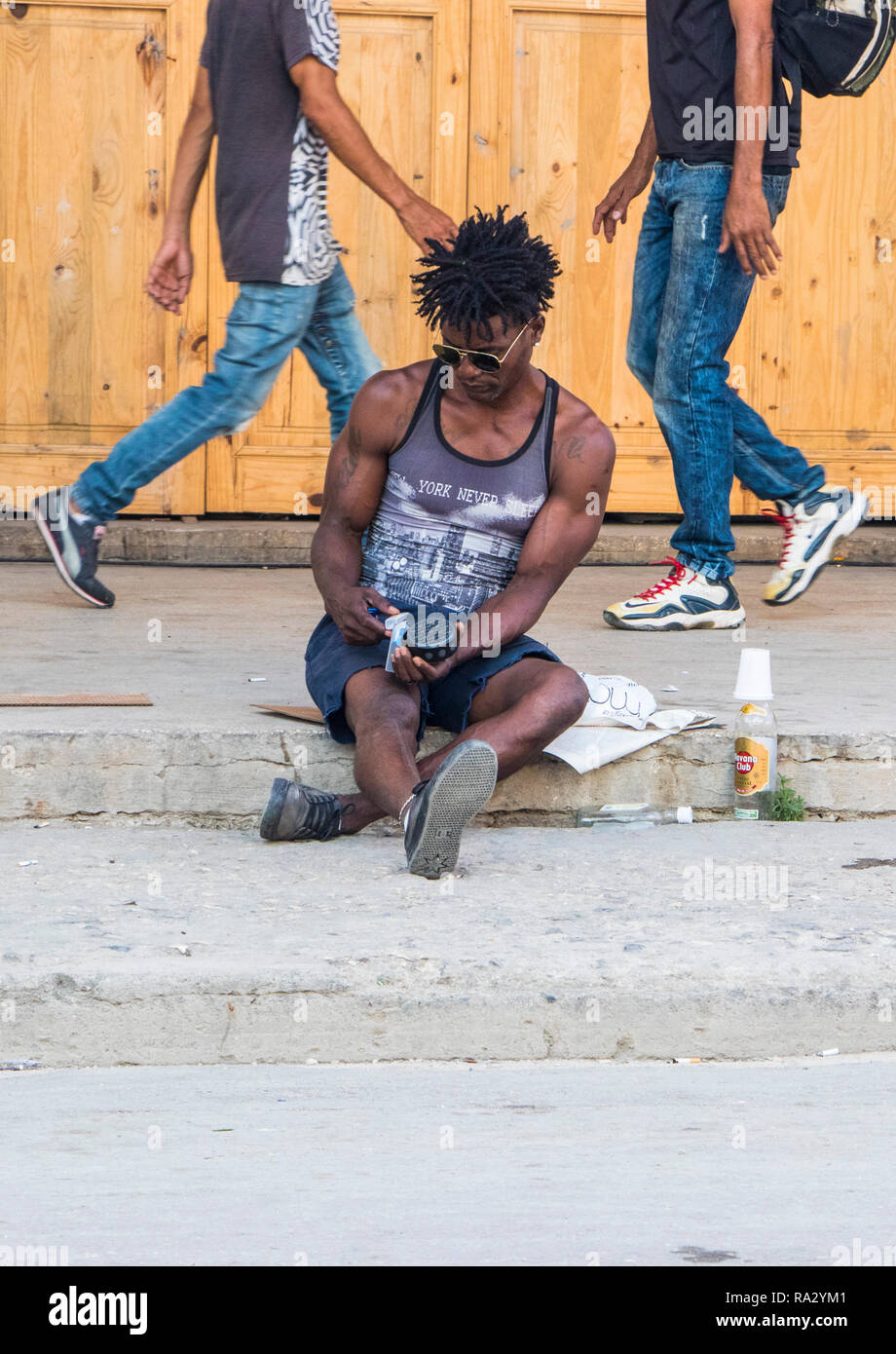 black Cuban youth sitting in street in Havana, Cuba, Caribbean Stock ...