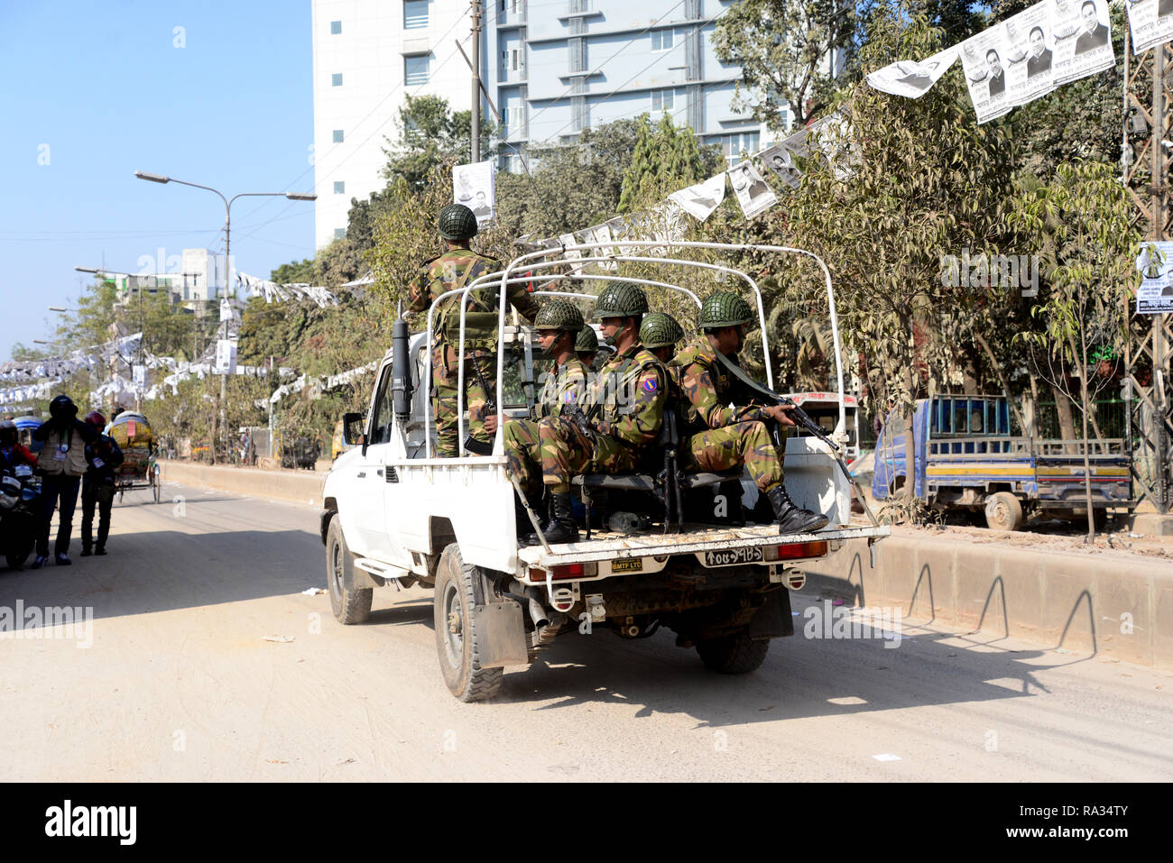 Dhaka, Bangladesh. 30th Dec, 2018. Bangladeshi army personnel drive a ...