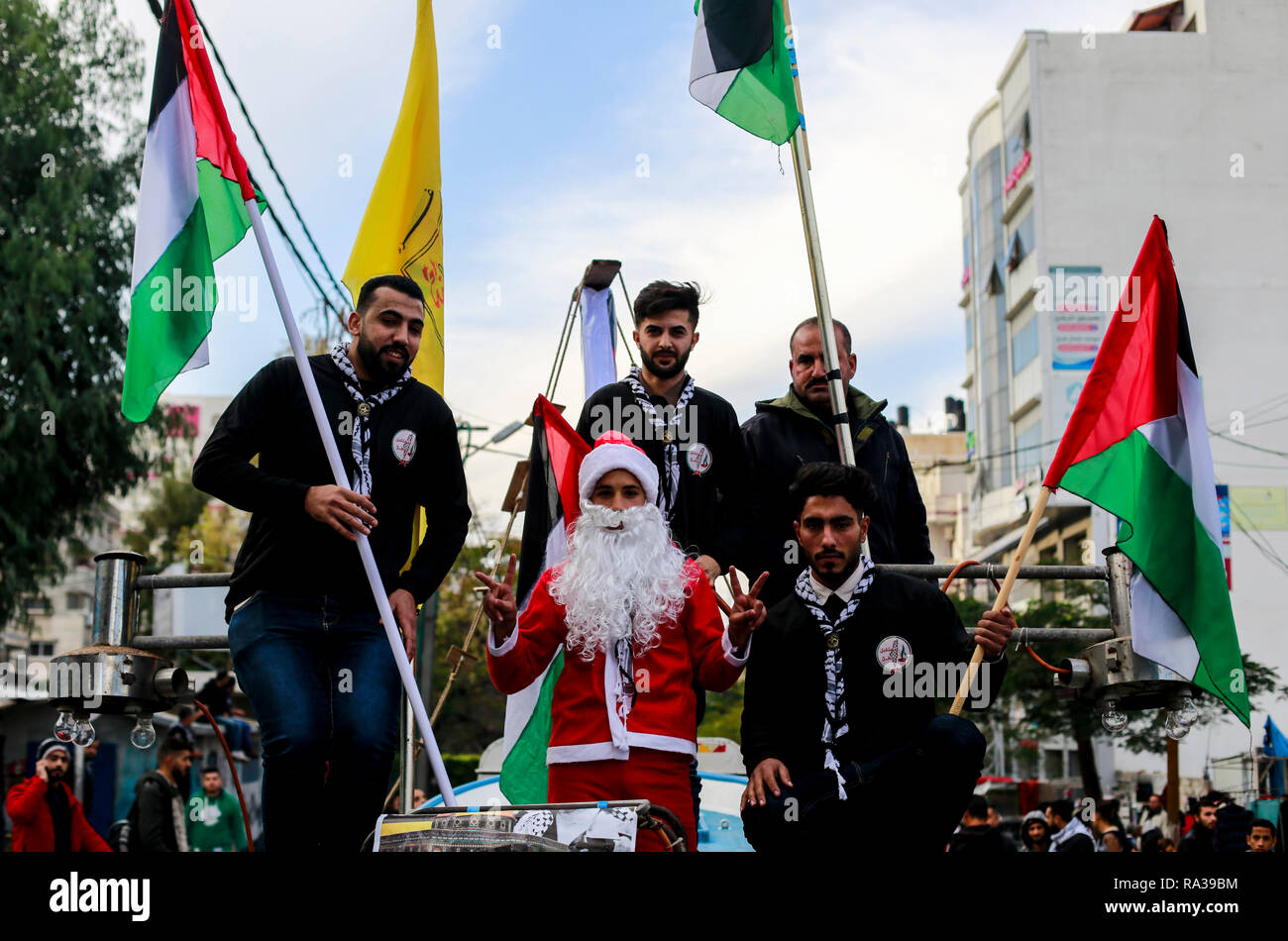 Palestinians seen with flags and Santa during the protest. Palestinians ...