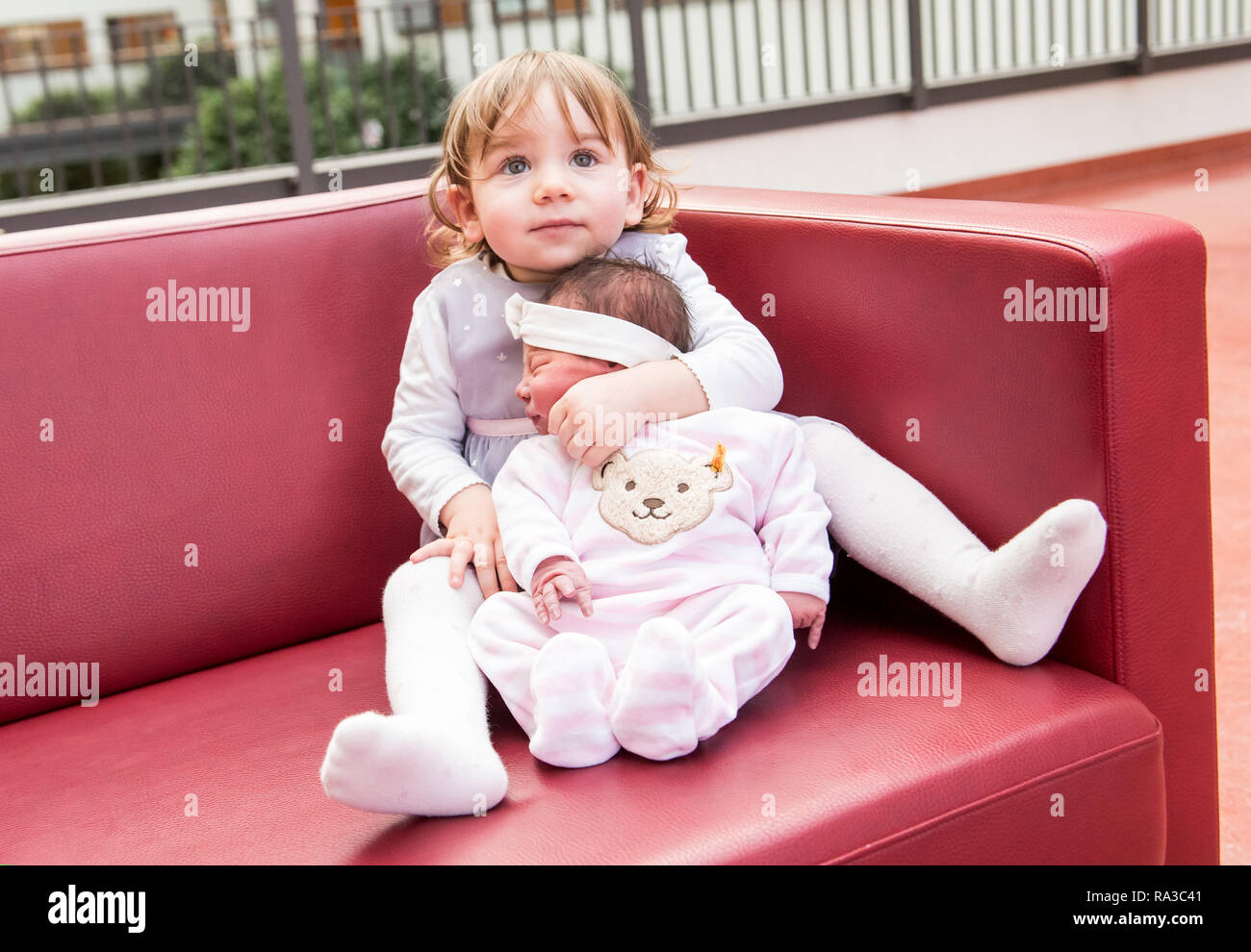 01 January 2019, Hamburg: Little Elena is being held by her sister ...