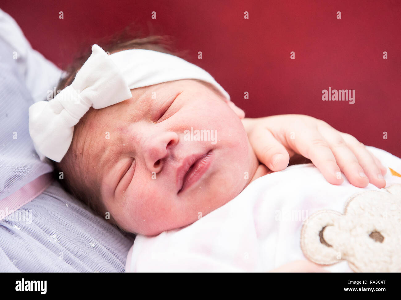 01 January 2019, Hamburg: Little Elena is being held by her sister ...