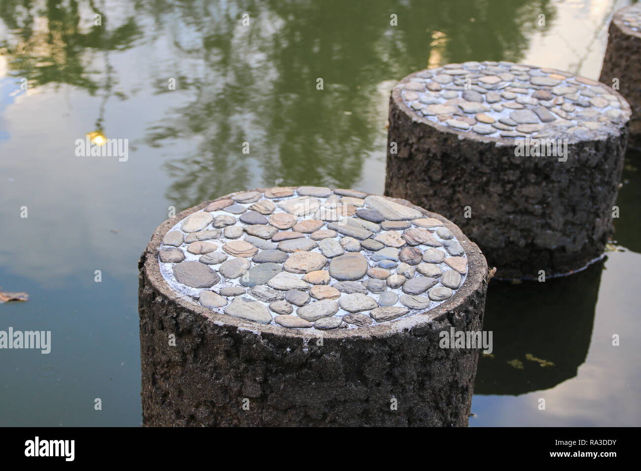 stone walkway across the pool in public park select focus with shallow ...
