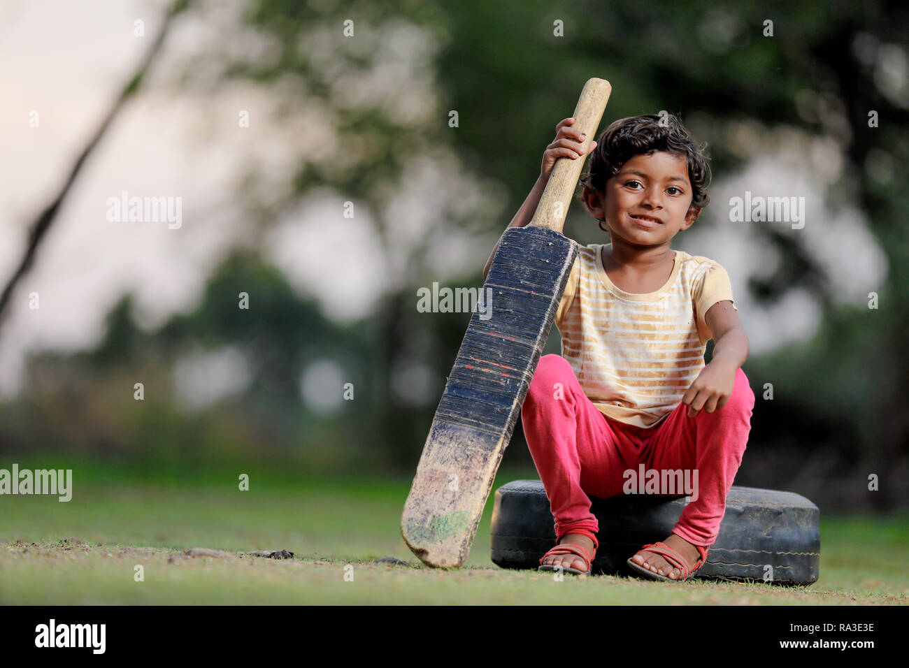 Indian kid playing cricket hi-res stock photography and images - Alamy