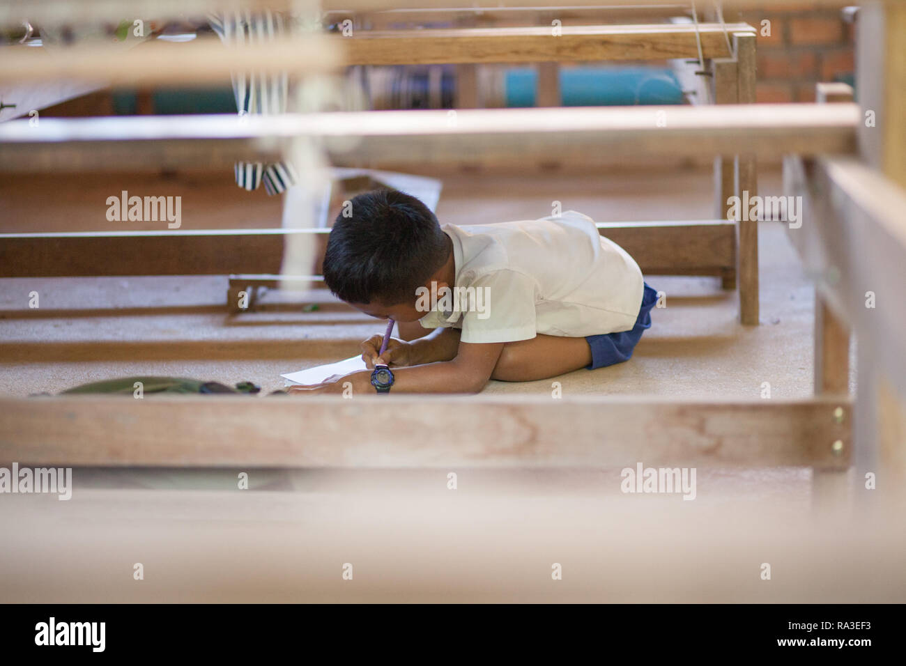 Hardworking kid was studying alone on floor Stock Photo - Alamy