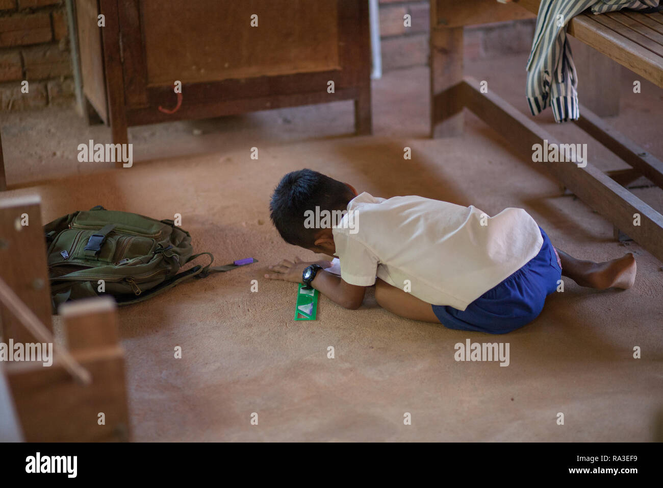 Hardworking kid was studying alone on floor Stock Photo - Alamy