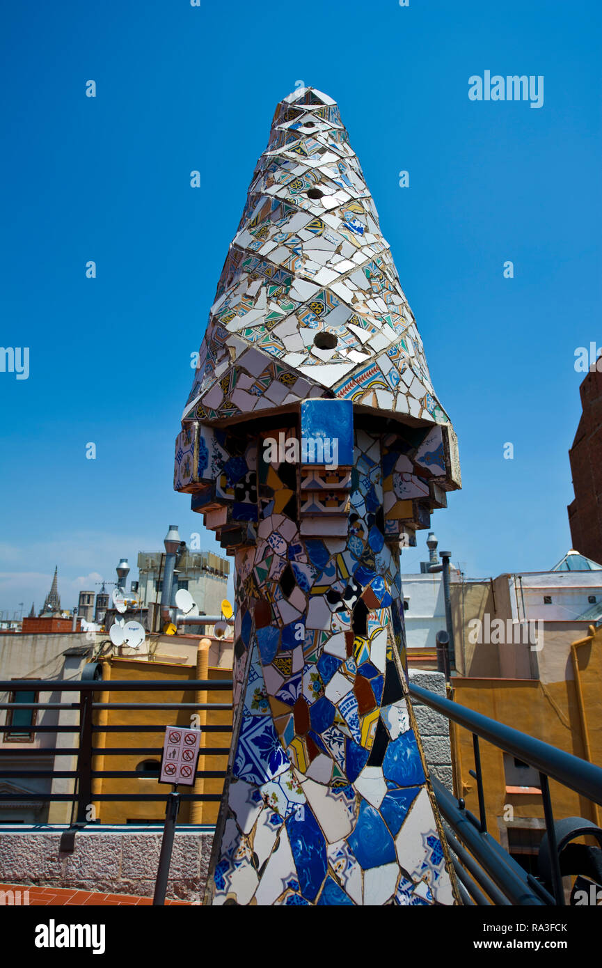 Colourful obelisks on the rooftop of the Palau Güell (Guell Palace), a ...