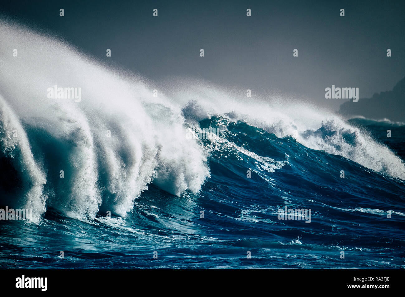 Big wave crash in the middle of the ocean with cliffs and coast in ...