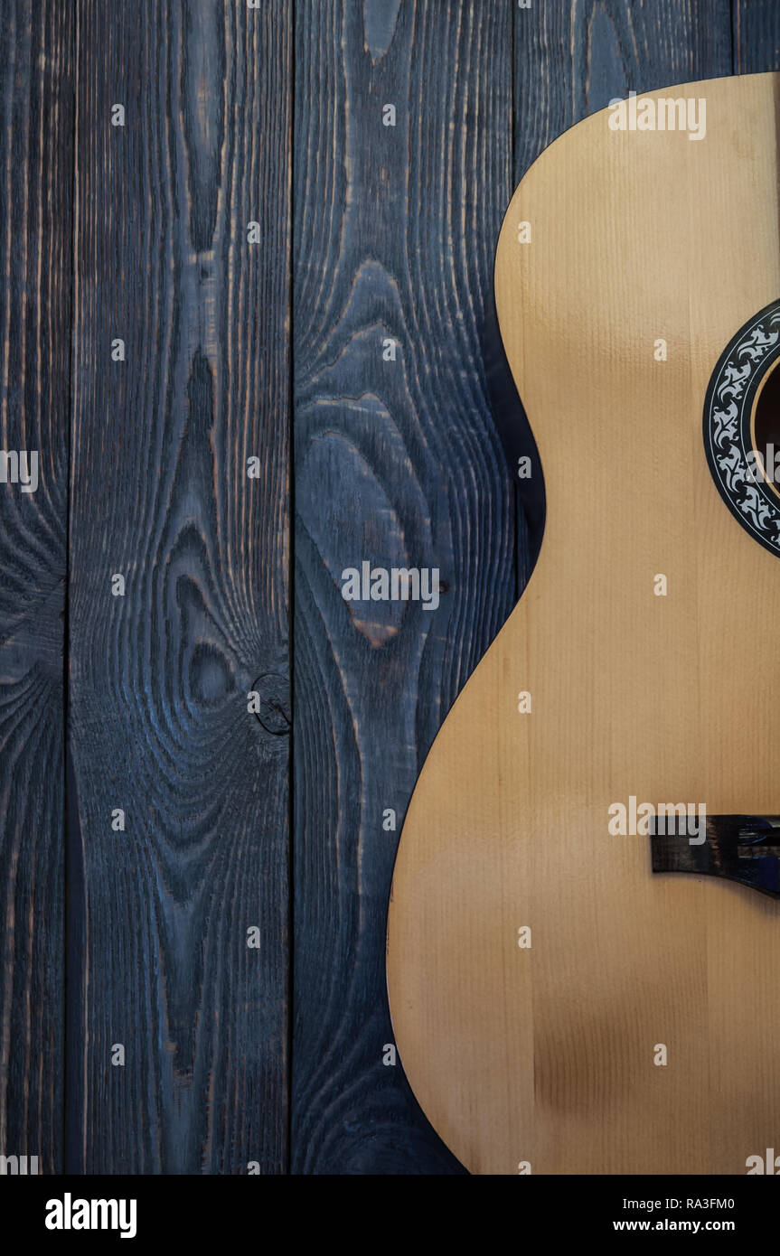 Part of the guitar standing on a wooden textured wall vertically Stock ...