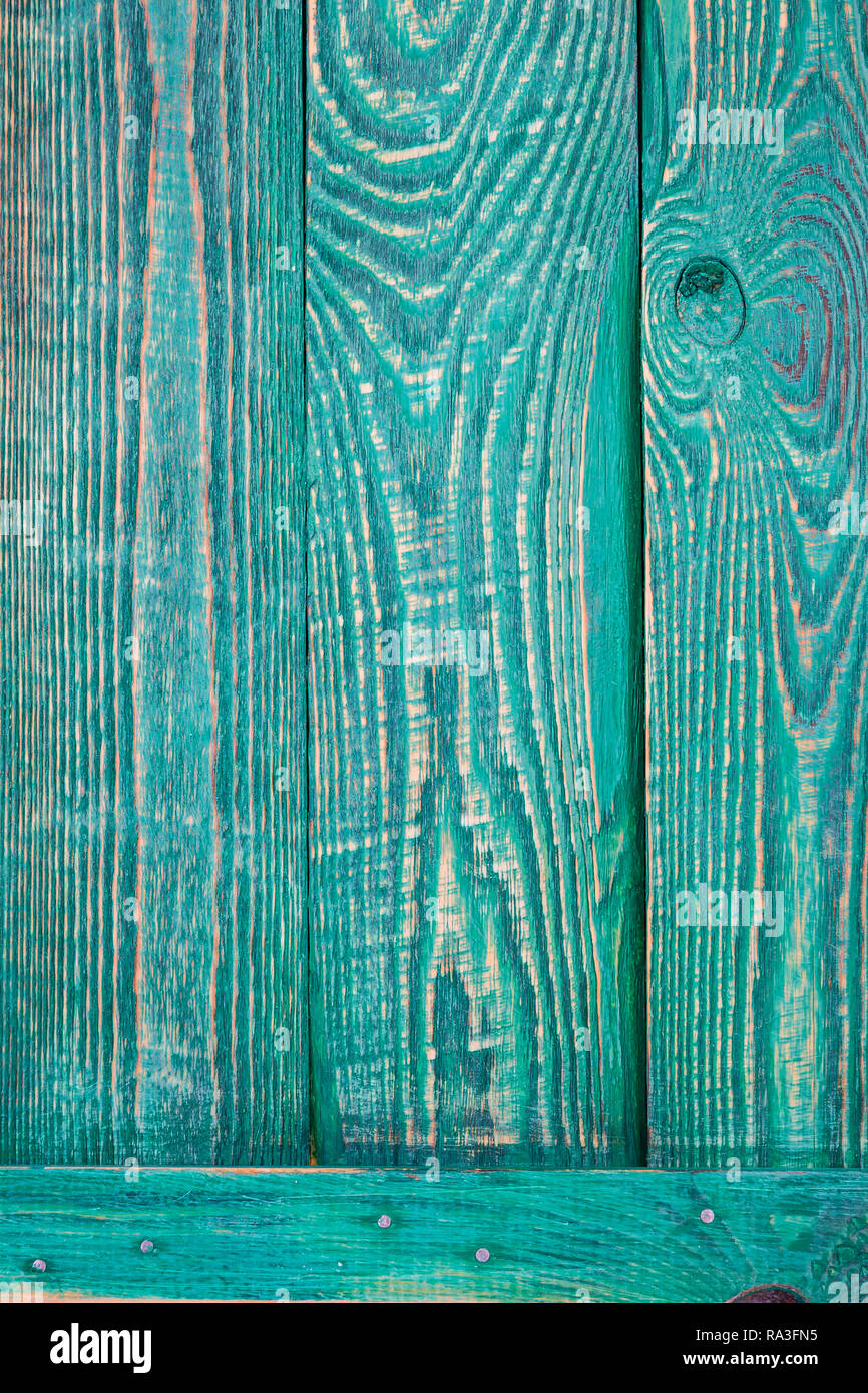 Vertical background of three green texture boards fastened by a ...