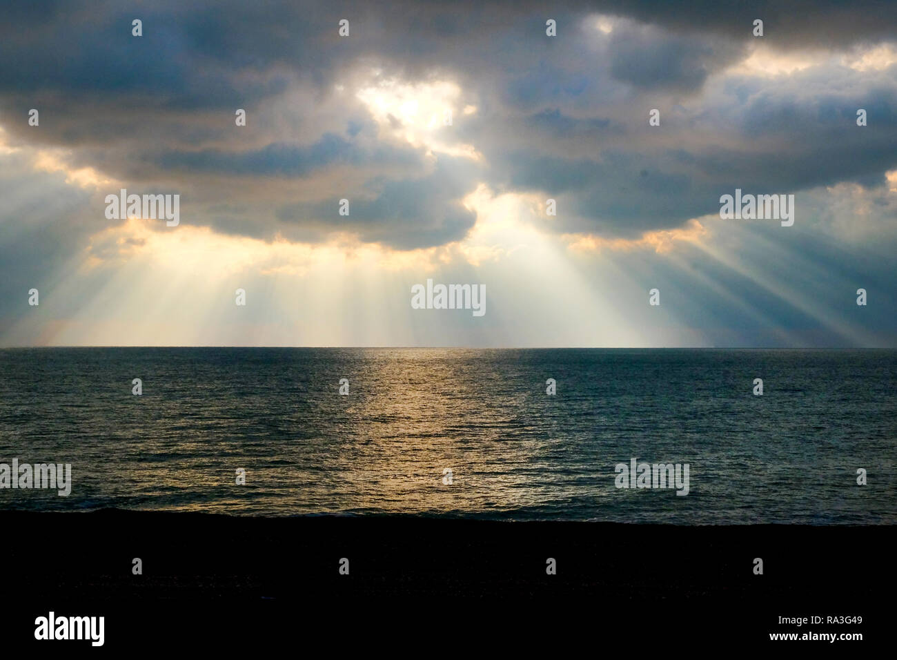 lots of long beams of sunlight shining through dramatic clouds casting ...