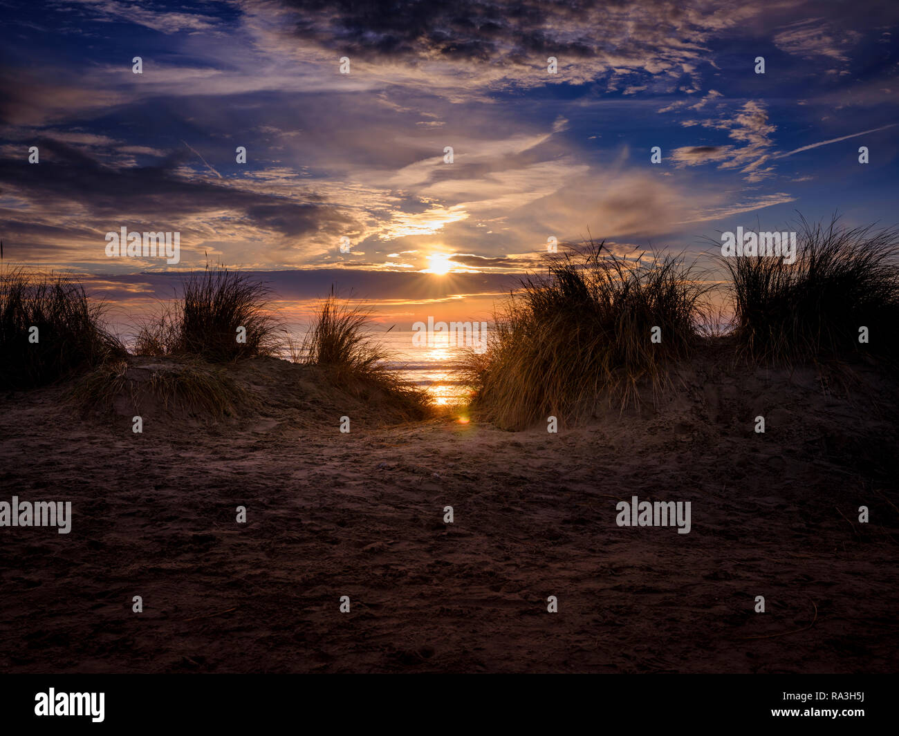 Sunset beyond sand dunes on West Wittering beach near Chichester, West ...