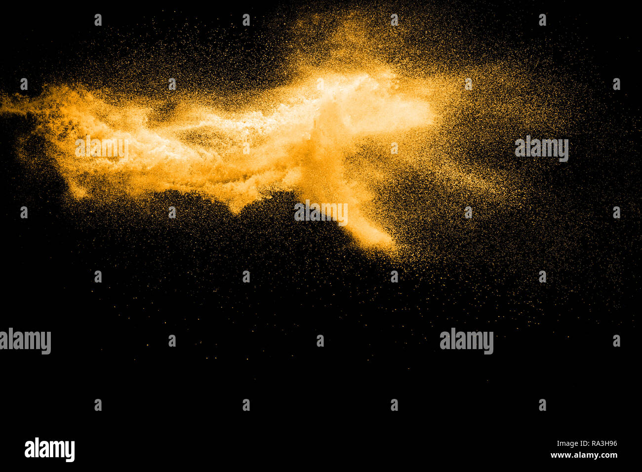Yellow sand explosion isolated on black background. Abstract sand cloud ...