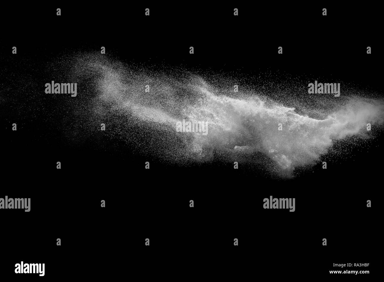 Bizarre forms of white powder explosion against dark background ...