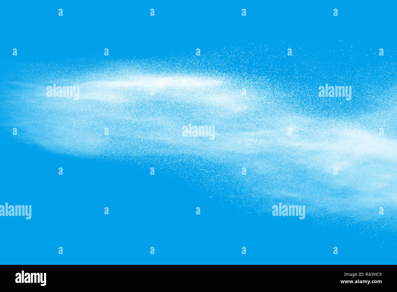 White color powder explosion isolated on blue background Stock Photo ...