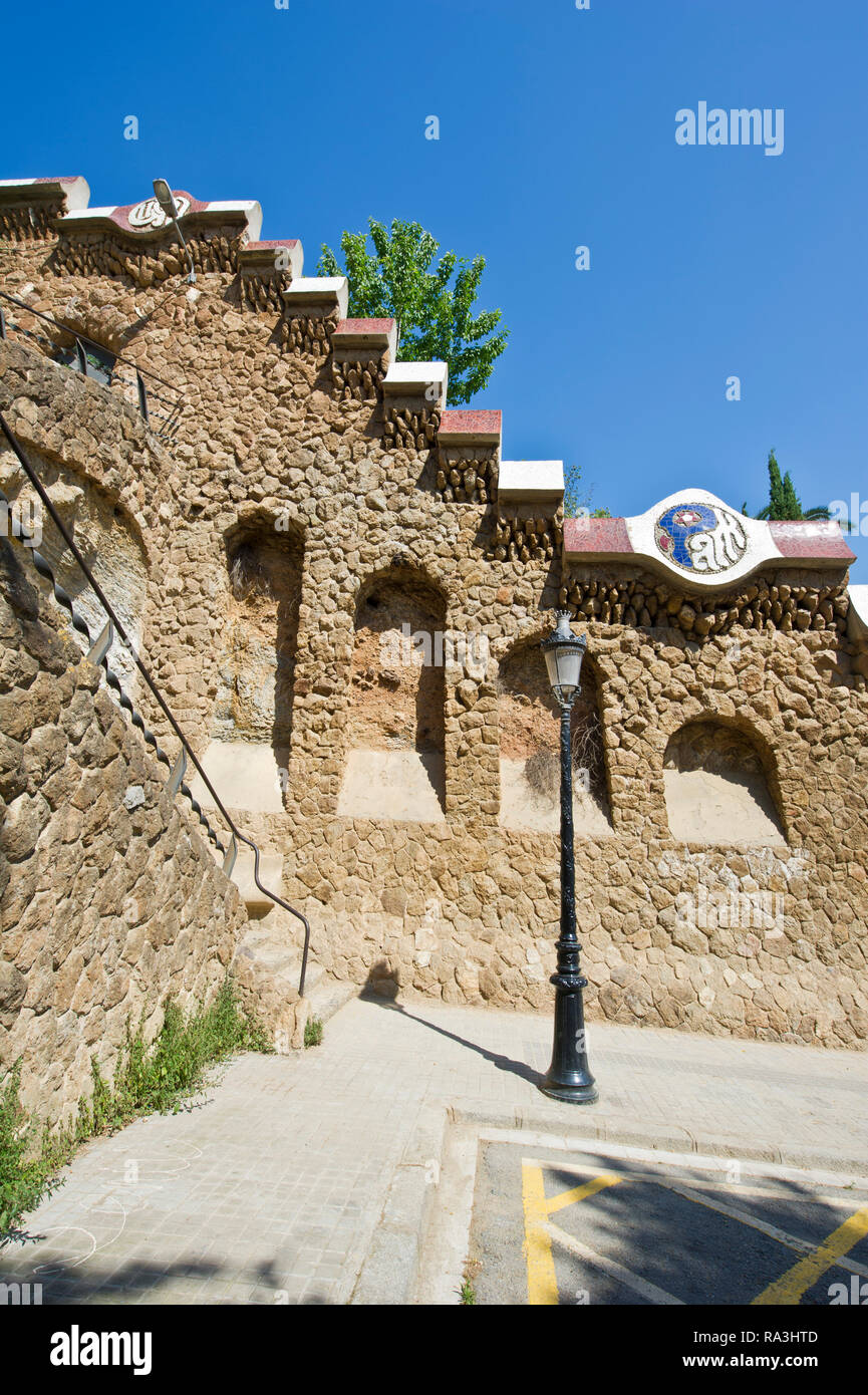 Stoney wall around the perimeter of the Park Guell designed by Antoni ...