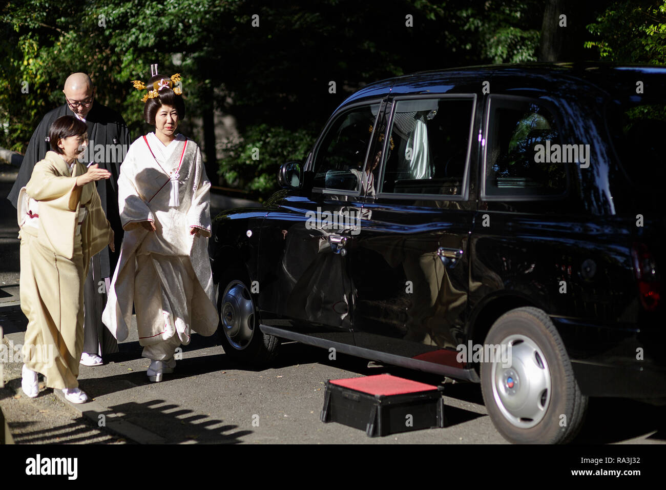 Shinto bride wearing the traditional white dress preparing to go in the ...