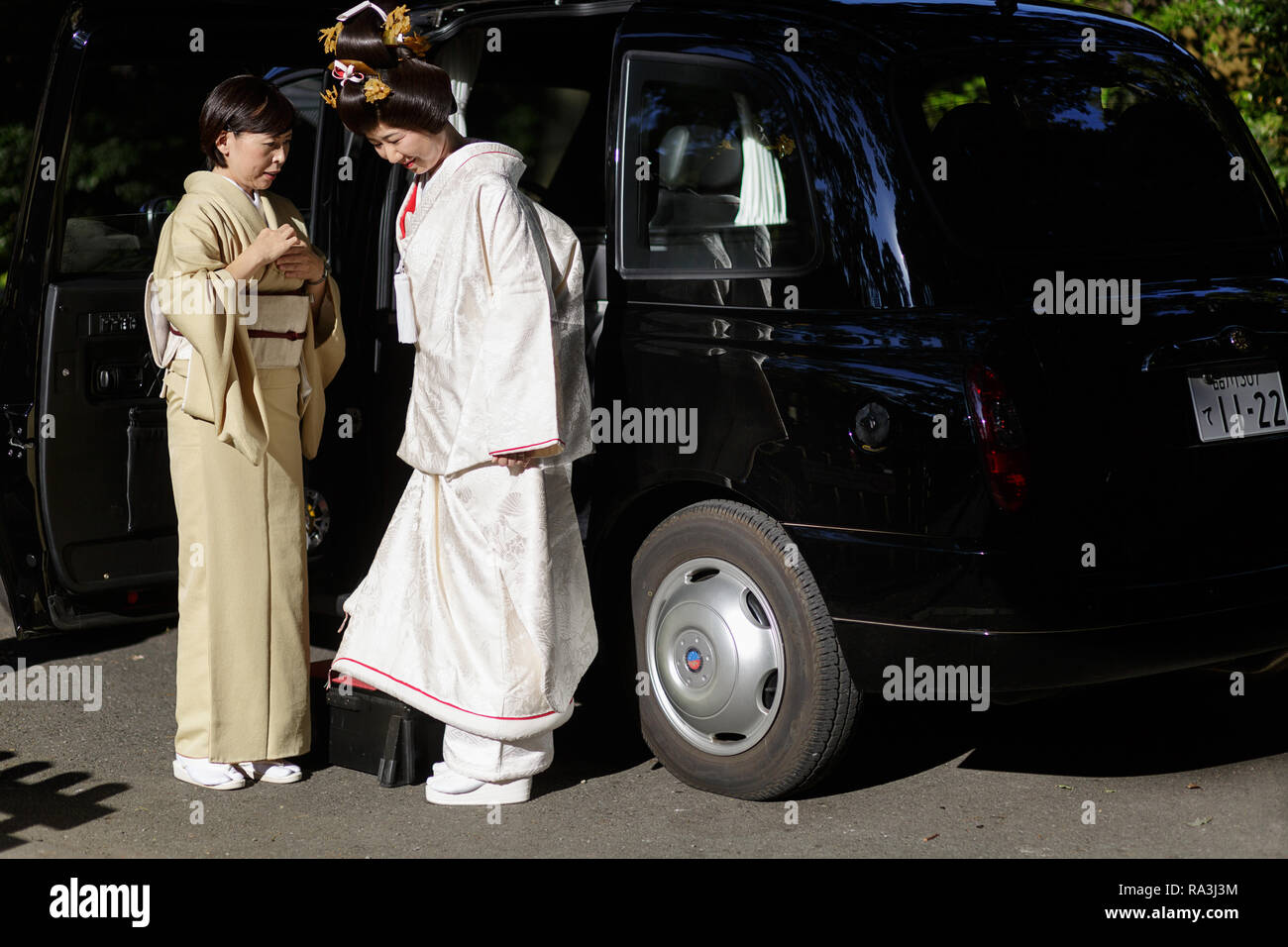 Shinto bride wearing the traditional white dress preparing to go in the ...
