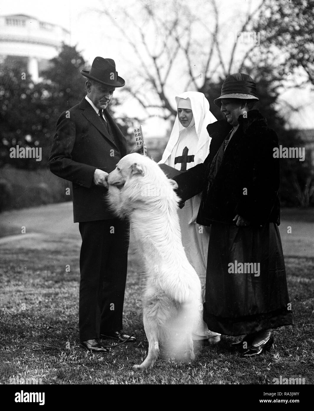 President Calvin Coolidge with dog outdoors with two women ca. 1924 ...