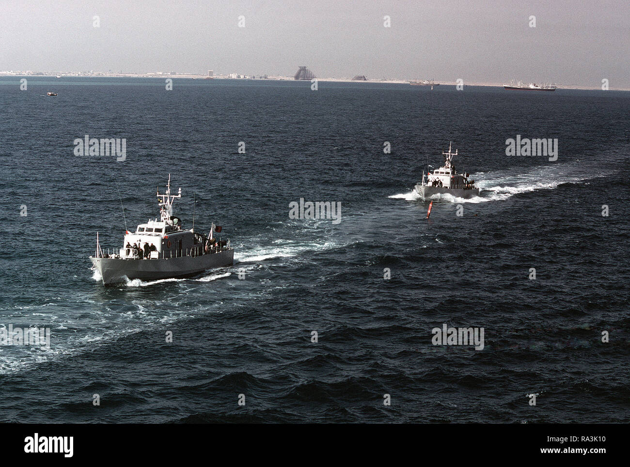 1979 - A port bow view of two Qatarian large patrol craft underway ...